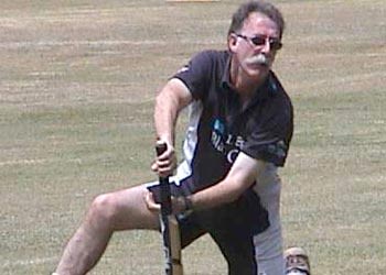 Coach David Trist uses a sawn-off piece of willow for catching practise ...