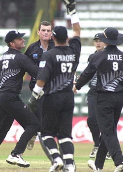 Kyle Mills who grabbed two wickets in his first over is cheered by his ...