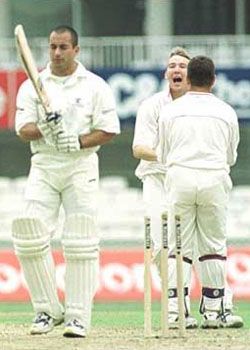 A dejected Hollioake walks back to the pavilion as Schofield celebrates ...