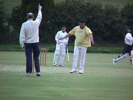 Umpire Brian Rutter's raised finger signals the dismissal of Khizer ...