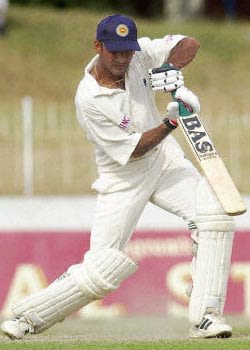 Atapattu punches one through the covers on the way to his century ...