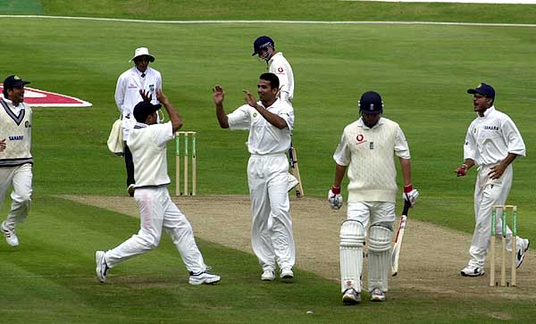 A dejected Robert Key trudges off the field whilst successful bowler ...
