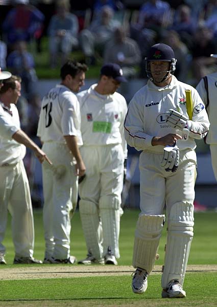 Stuart Law leaves the field at the end of his innings of 77 ...