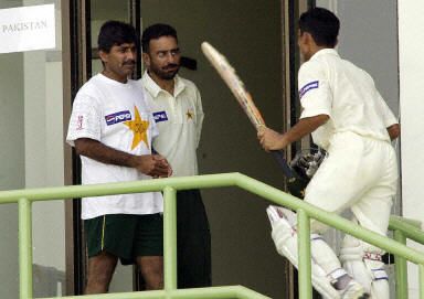 Yasir Hameed (R) is congratulated by coach Javed Miandad (L) and the ...