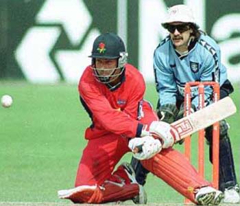 Graham Lloyd gets in position to execute a reverse sweep | ESPNcricinfo.com