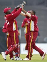 Courtney Browne and Dwayne Bravo celebrate the wicket of Inzamam-ul-Haq ...