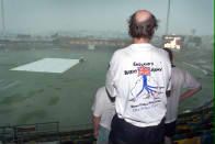 An England supporter looks out over the flooded Gabba | ESPNcricinfo.com