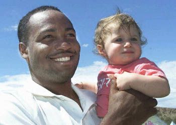 Lara holding one year old baby Wednesday Pyle | ESPNcricinfo.com