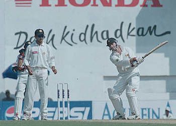 Ganguly watches Whittall as he uses his bat to get rid of an insect ...