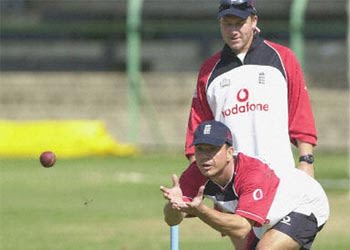 Martyn Ball checks out how hopeful stumper Warren Hegg gathers the ball ...