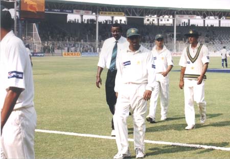 Umpire Bucknor returning to the pavilion along with the home team ...