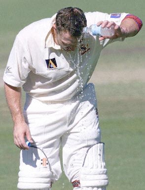 Michael Slater pours water on his head at the Adelaide Oval ...