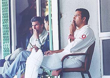 James Ormond, all padded up, smokes contemplatively in the pavilion ...